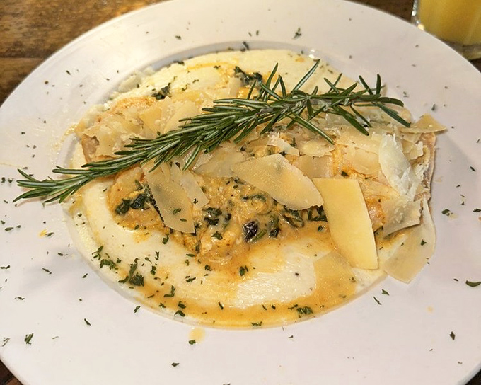 Salmon and grits playing so nicely together you'd think they grew up in the same ocean. That rosemary sprig is the exclamation point.