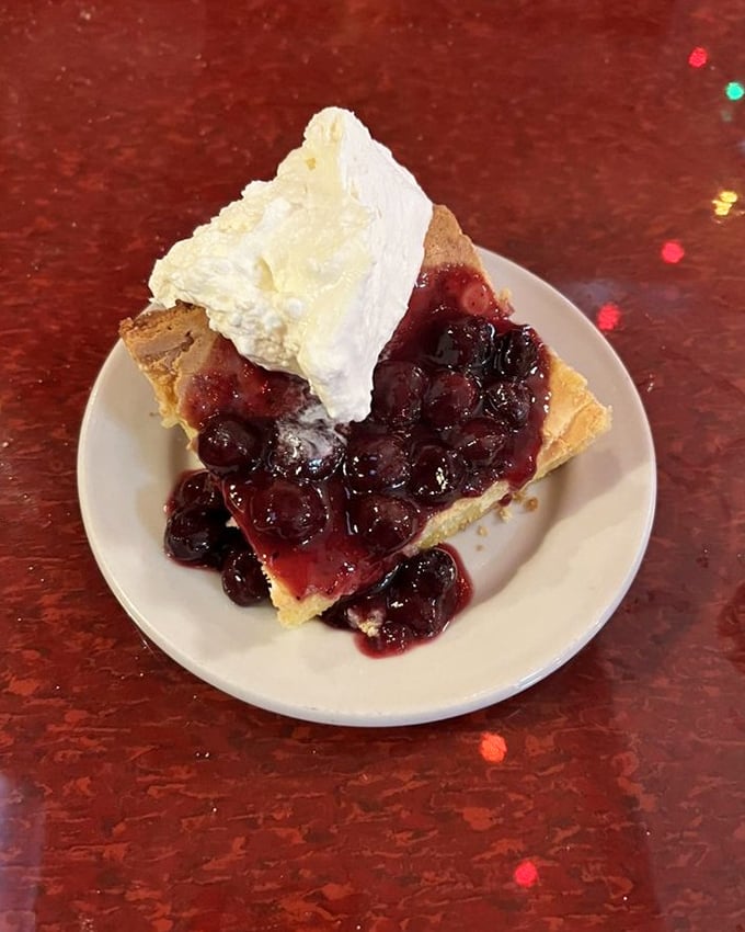 Cherry pie that makes you understand why people used to cool these on windowsills. That cloud of whipped cream isn't just topping&mdash;it's the cherry's heavenly reward.