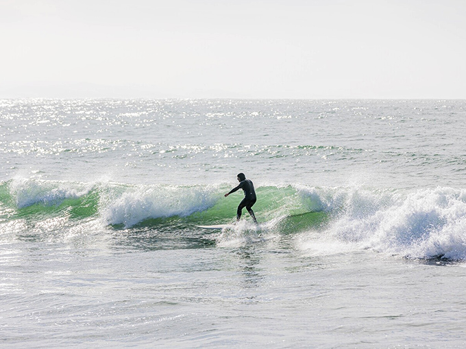 Poetry in wetsuit form. When surfer meets perfect wave, it's like watching a spontaneous dance performance where nature provides both stage and music.