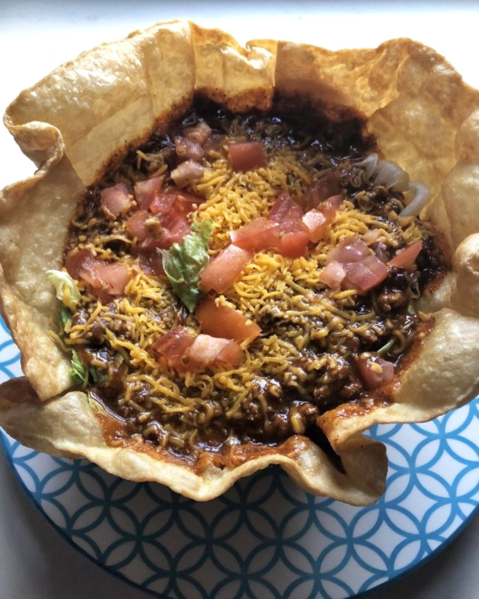 A taco salad that defies gravity and expectations. That edible bowl is the superhero cape this comfort food deserves.