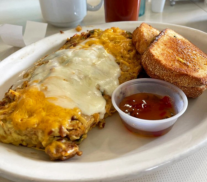 They call this "The Cure" for a reason. Melted cheese blankets crispy hash browns with toast standing by for the perfect bite delivery system.