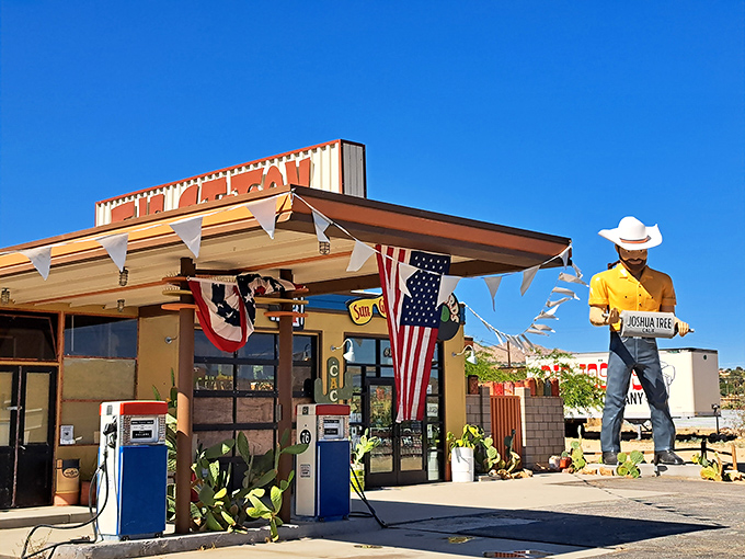 The vintage gas station has been pumping nostalgia longer than fuel, complete with a cowboy sentinel who never complains about the heat.