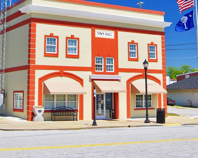 The Town Hall's cheerful orange-and-cream facade feels like a deliberate choice to brighten civic duty with a splash of optimism.