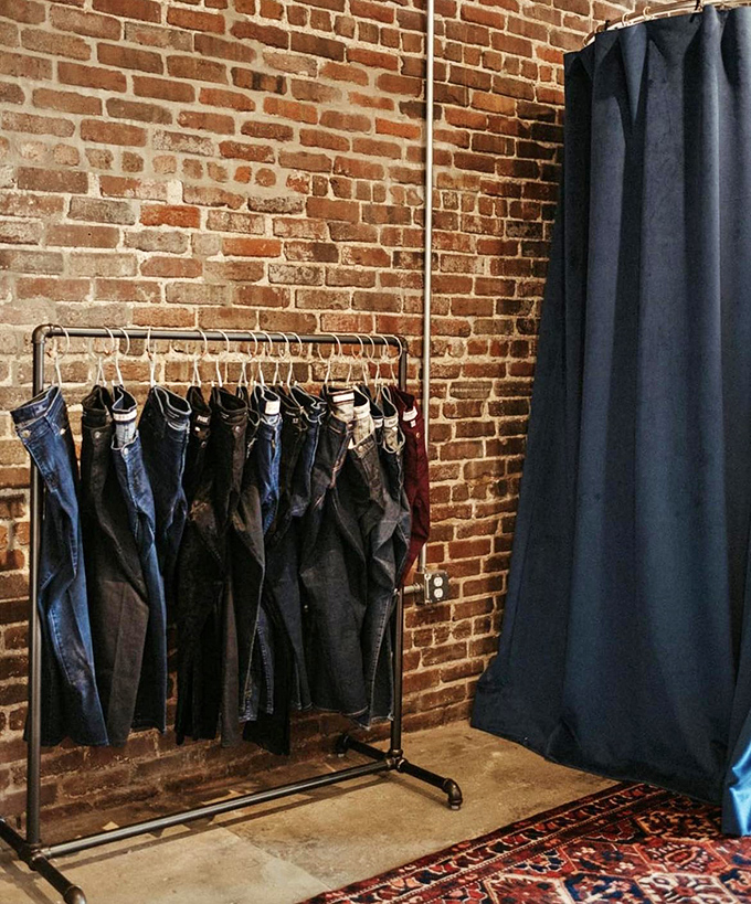 Denim heaven against rustic brick&mdash;this minimalist display proves sometimes less really is more in the world of sustainable fashion.