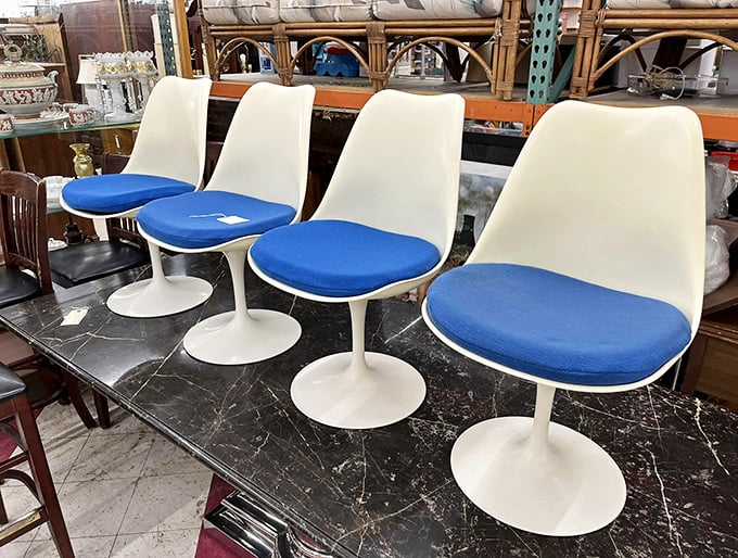 Space-age tulip chairs that would make the Jetsons jealous. Mid-century modern meets blue cushion comfort in this retro quartet.