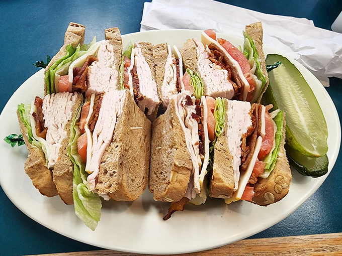 The club sandwich – America's most reliable lunch order, executed with architectural precision. That pickle isn't just garnish – it's necessary contrast.