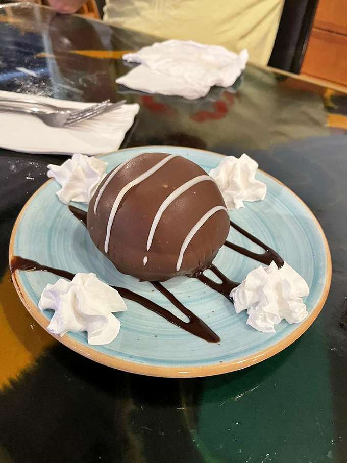 The Tuxedo Bomb arrives dressed more formally than most Florida residents, delivering chocolate decadence with a side of whipped cream diplomacy.