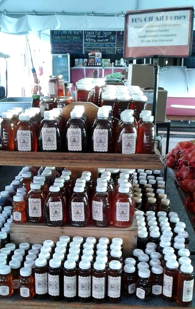 Liquid gold, bottled and beautiful. This local honey display showcases nature's sweetest creation in various shades of amber perfection.