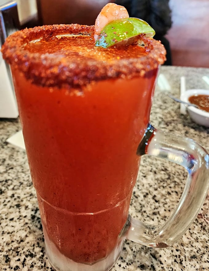 That rim isn't just spiced&mdash;it's weaponized with flavor. The michelada's vibrant red promises a kick that delivers on every sip.