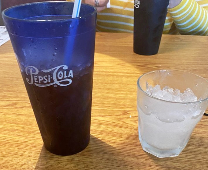 The simple pleasure of an ice-cold drink in a blue glass – because seafood feasts demand proper hydration between bites.
