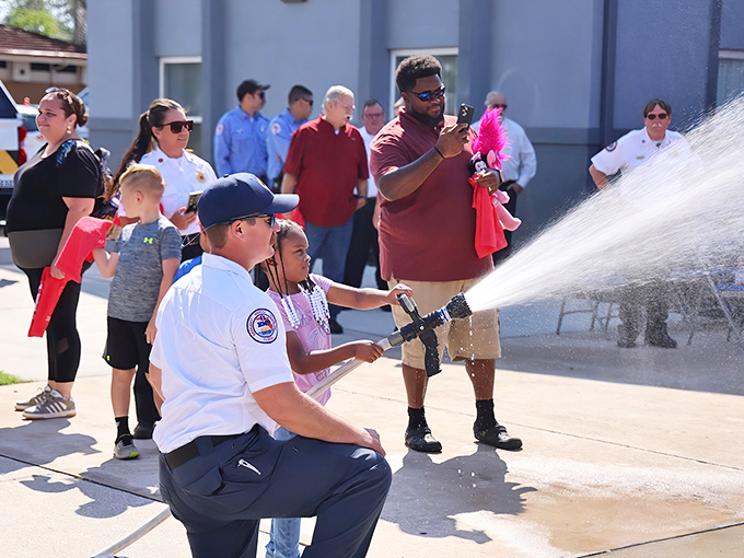 Community traditions bring generations together in Deltona. Nothing says "welcome" to a new fire truck like letting kids handle the hose.