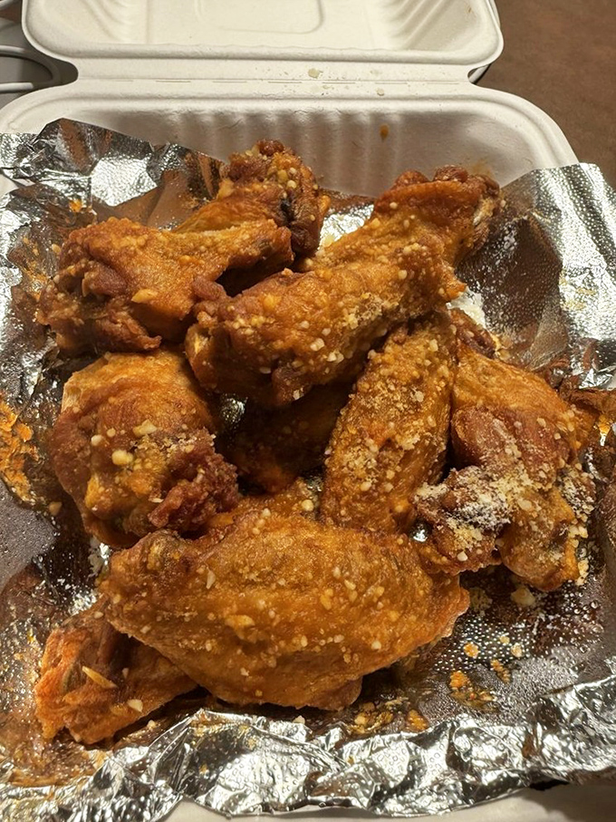 Golden-fried perfection in a takeout container. These wings aren't just food&mdash;they're a commitment to flavor that demands your full attention.
