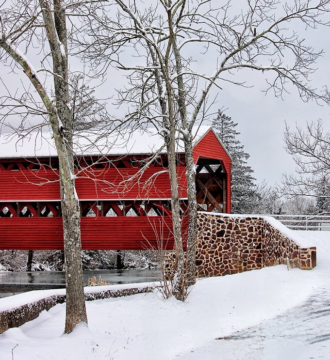 Winter's white blanket creates a stunning backdrop for the bridge's bold red siding&mdash;a Christmas card scene waiting to be captured.