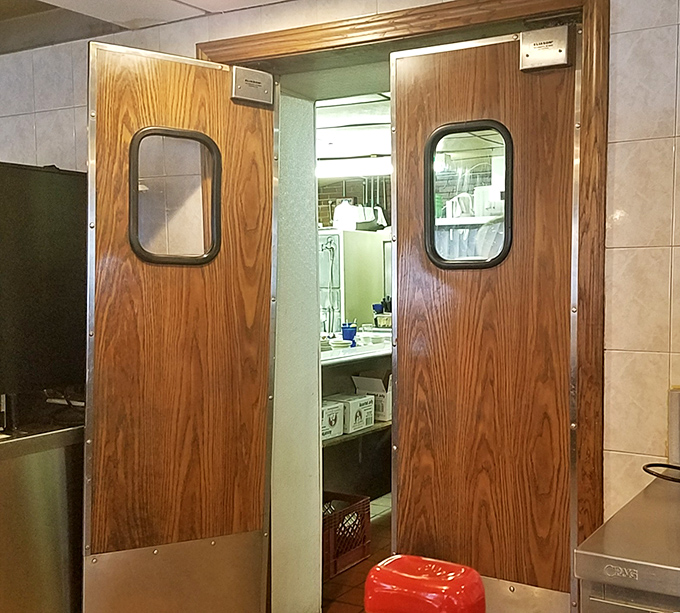 Those swinging kitchen doors have witnessed decades of short-order magic. Like the entrance to Narnia, but with hash browns instead of snow.