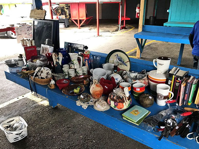 This blue table of miscellaneous treasures is like an analog version of your Facebook Marketplace feed&mdash;chaotic, mysterious, and utterly irresistible.