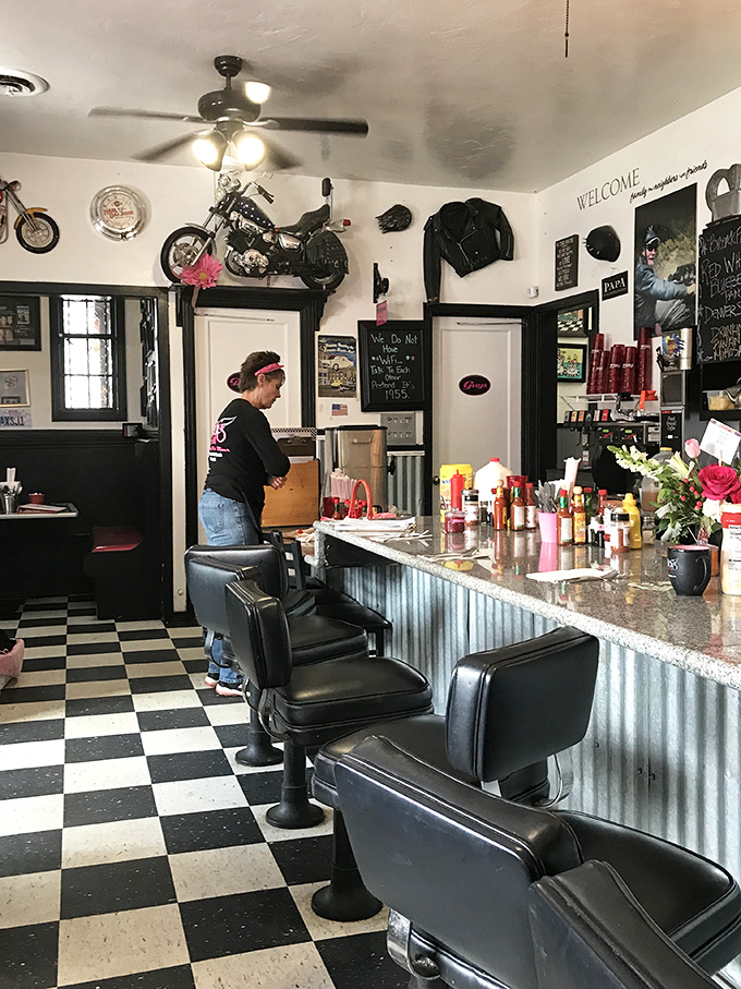 The counter where breakfast dreams come true, complete with vintage bar stools and motorcycle memorabilia that screams "cool" without trying too hard.