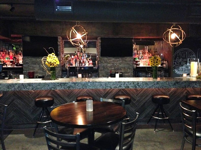 The bar area beckons with sophisticated lighting and the promise of drinks that can stand up to robust barbecue flavors.