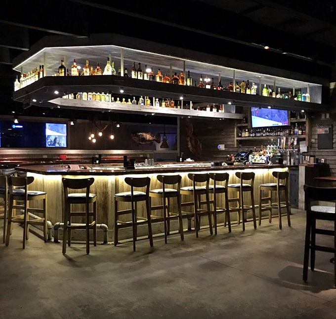 The bar gleams with promise, bottles illuminated like treasures, each one holding the potential for your next favorite vacation story.