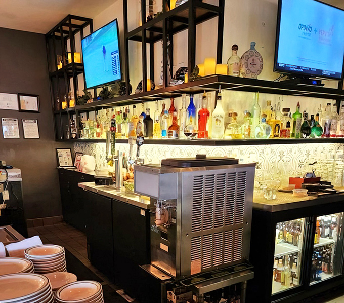 The well-stocked bar stands ready to craft the perfect margarita companion to your chimichanga adventure ahead.