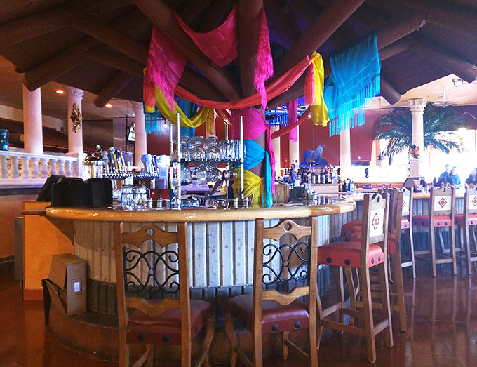 
A bar that understands its mission: to provide colorful drinks under equally colorful decorations. Tequila bottles standing at attention, ready to serve. 