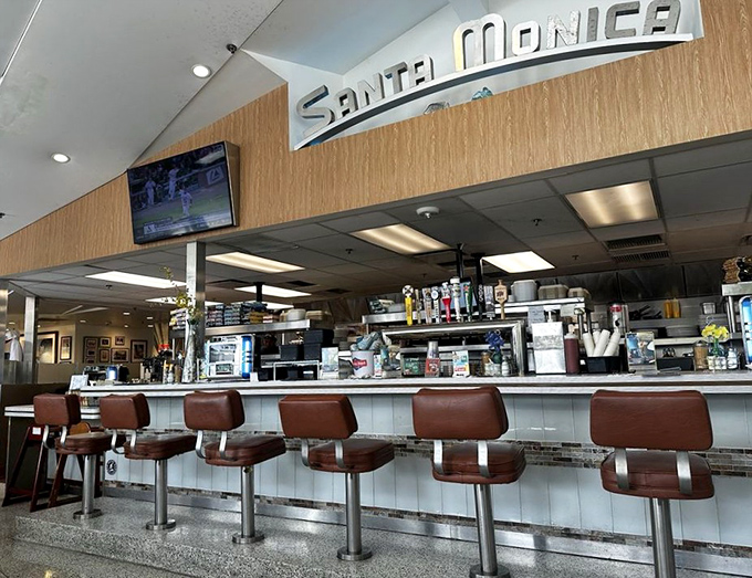 Counter seating: where solo diners become regulars and the "Santa Monica" sign reminds you you're somewhere special, not just anywhere USA.