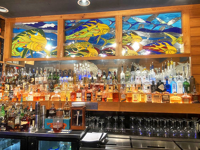 The bar's stained glass fish swim eternally above bottles of premium spirits – a colorful backdrop for crafting cocktails that complement the ocean's bounty.