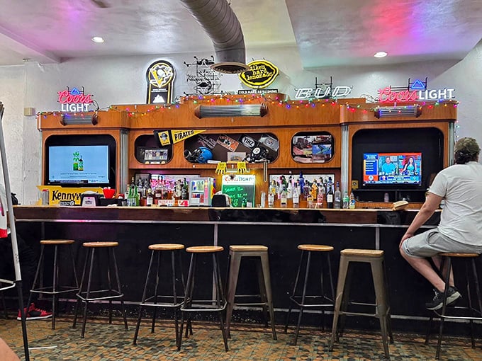 The bar area glows with neon beer signs and Pittsburgh sports memorabilia&mdash;a shrine where sandwich pilgrims can wash down their conquests with cold brews.