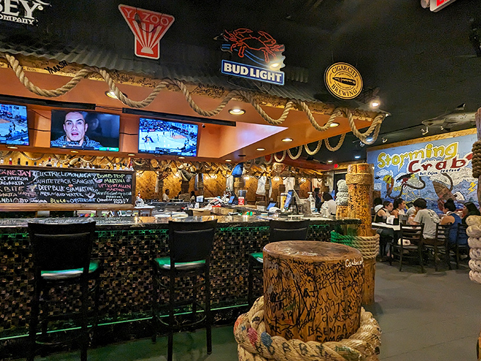 The bar area glows with neon promise. Those TVs aren't the main attraction&mdash;they're just something to glance at between bites.