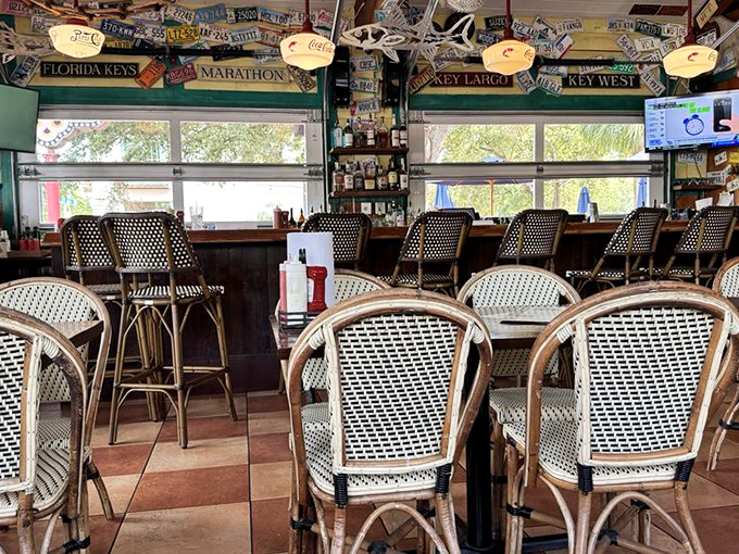 The bar area where license plates from visitors' hometowns create a roadmap of seafood pilgrims. Florida Keys signs remind you where the inspiration comes from.