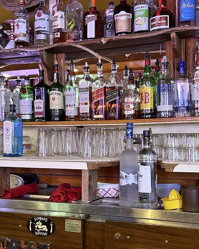 A bar shelf that says, "We're not here to impress you with obscure spirits&mdash;we're here to pour you something that works."