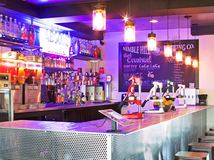A bar that glows with possibility. Like a Broadway stage for bottles, this is where liquid magic happens under purple lights.