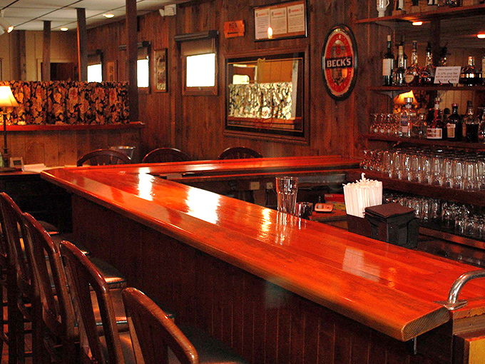 The bar's cherry-wood gleam invites elbows and stories—a place where "just one more" isn't a question but a certainty.