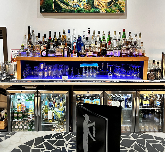 A liquid rainbow of possibilities lines the bar shelves, ready to complement your protein parade with something spirited and bright.