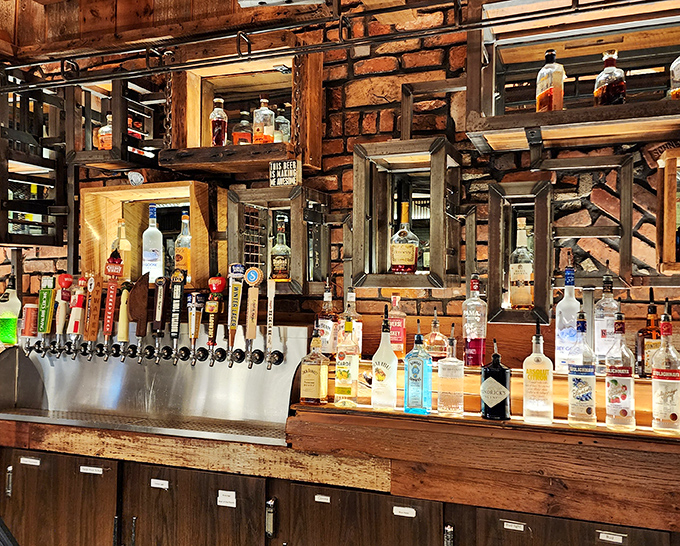 A bar backed with brick and wood showcases an impressive spirits collection. The perfect place to contemplate the finer points of bourbon and brisket.