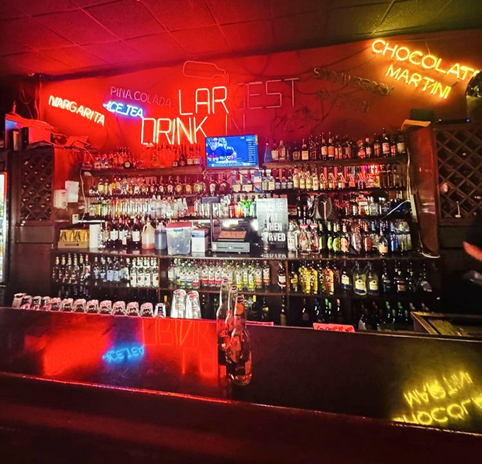 The bar area glows with neon promise, offering liquid courage before you attempt to finish that whole cheesesteak in one sitting.