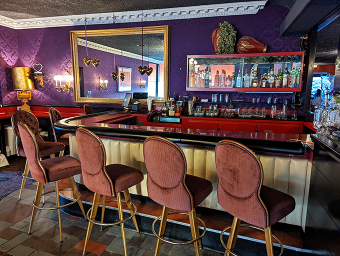 The bar area strikes that perfect balance between swanky and comfortable&mdash;purple walls, red accents, and padded stools that invite you to stay awhile.