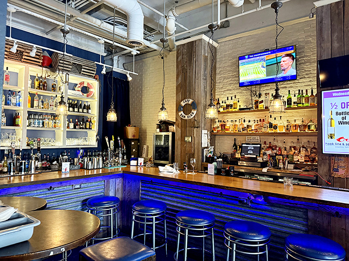 The bar glows blue like the perfect ocean day. This is where cocktails are crafted with the same care as the kitchen gives its seafood.