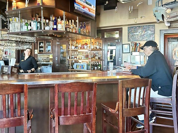 The bar area beckons with the promise of perfectly mixed cocktails and the kind of conversations that make strangers into friends.