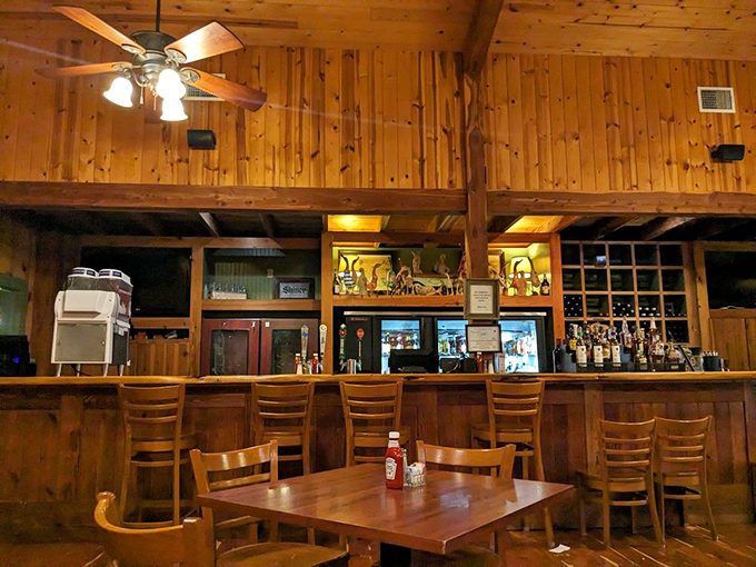 The bar area offers a front-row seat to liquid craftsmanship, all wrapped in the warm embrace of knotty pine.