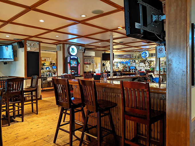 The bar area beckons with promises of spirited conversations and expertly crafted drinks. Where strangers become friends over shared stories and cold beverages.