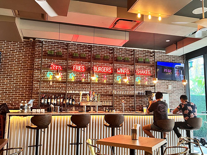 The bar's neon signs spell out life's essentials: Beer, Fries, Burgers, Wings, Shakes. It's basically the food pyramid according to your inner child.