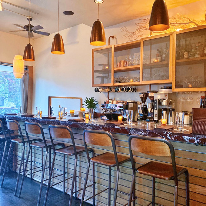 Copper pendants illuminate wooden bar tops where strangers become friends. The kind of place where "just one drink" turns into dinner and dessert.