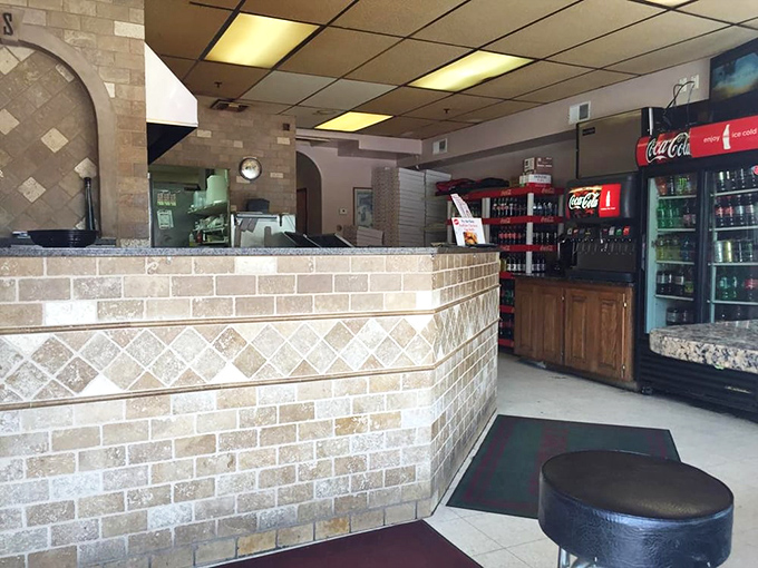 The beverage counter stands ready for thirsty patrons. In pizza math, a cold soda plus a hot slice equals pure contentment.