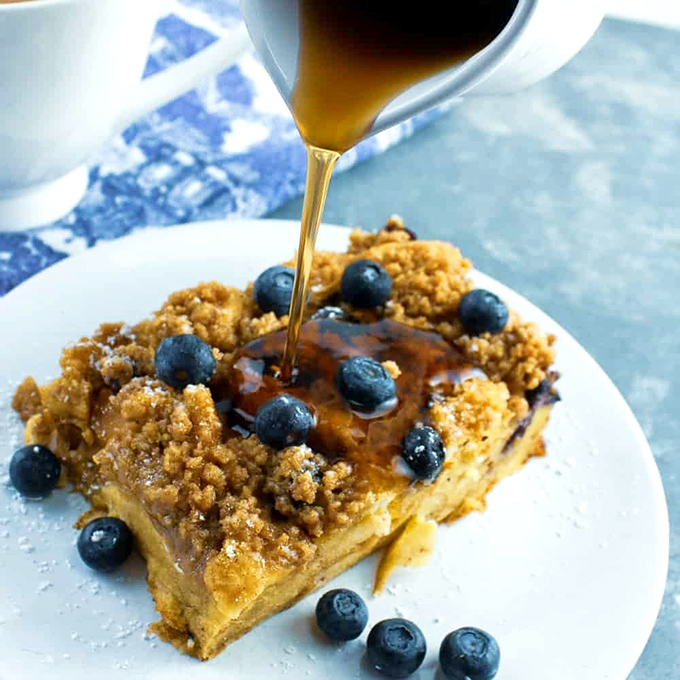 Blueberry streusel French toast with maple syrup cascading down like a sweet waterfall – breakfast that doubles as dessert is always the right choice.