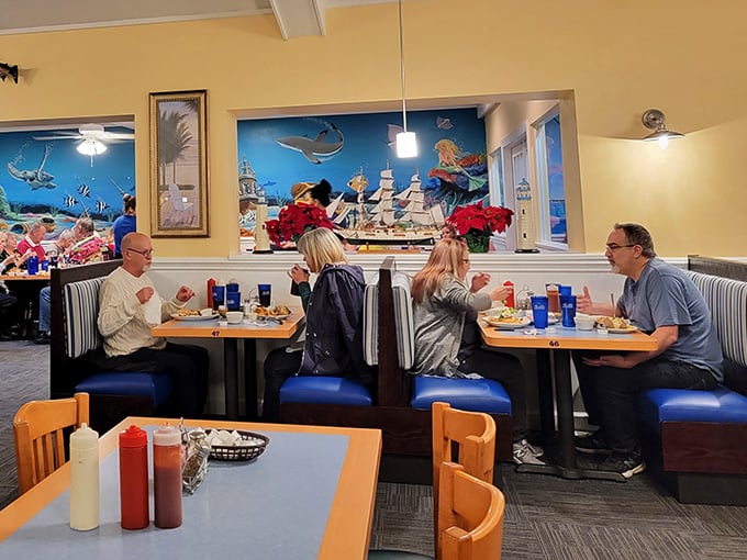 Booth seating with ocean murals &ndash; the next best thing to dining on a yacht, minus the seasickness and pretentiousness.