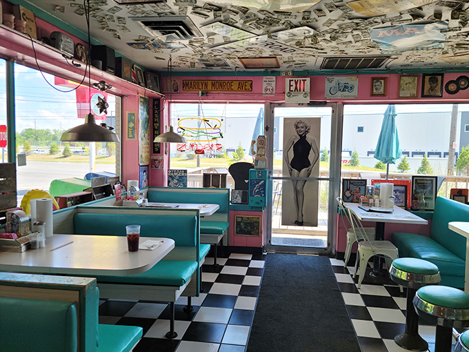 A squeeze bottle of ketchup, perfectly crisp fries, and a burger on a checkered plate—some things don't need reinvention, just appreciation.