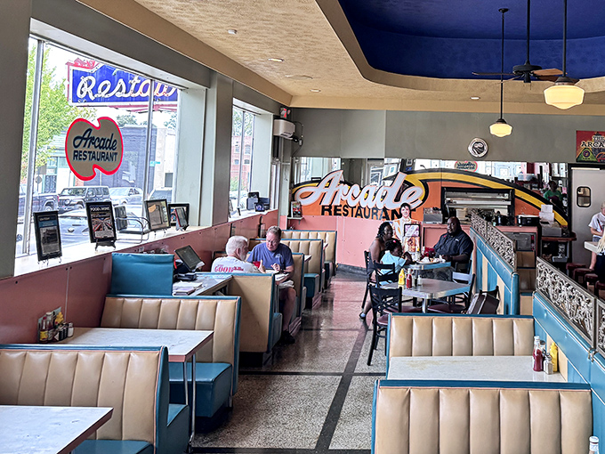 Booths where strangers become friends and friends become family. That blue ceiling hovers like Memphis sky over countless conversations and confessions. 