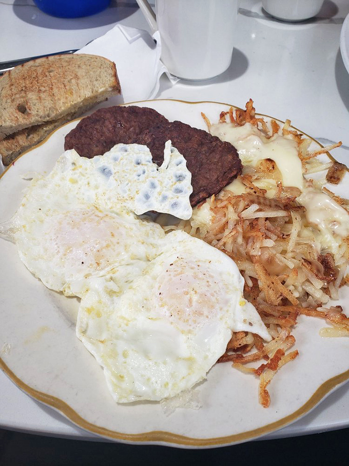 The classic American breakfast plate—where eggs, meat, and potatoes gather for their daily meeting about how to start your day right.
