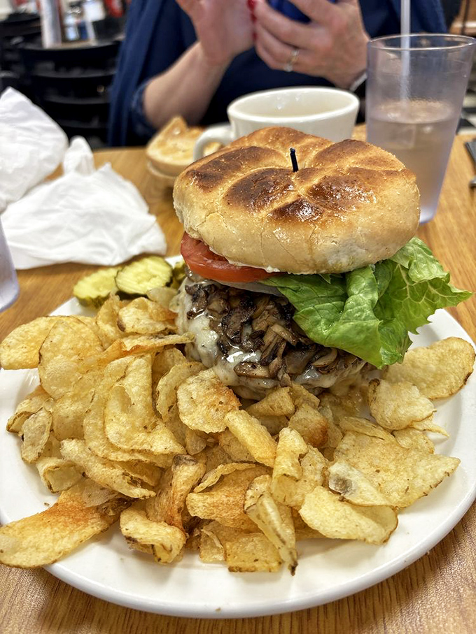 A burger that doesn't need pretension to impress, surrounded by chips that crunch loud enough to announce your satisfaction to the room.