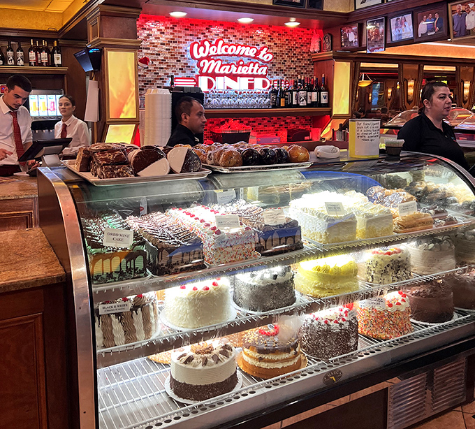 The dessert case&mdash;where willpower goes to surrender. Each cake stands like a sugary skyscraper, architectural marvels of butter and flour.